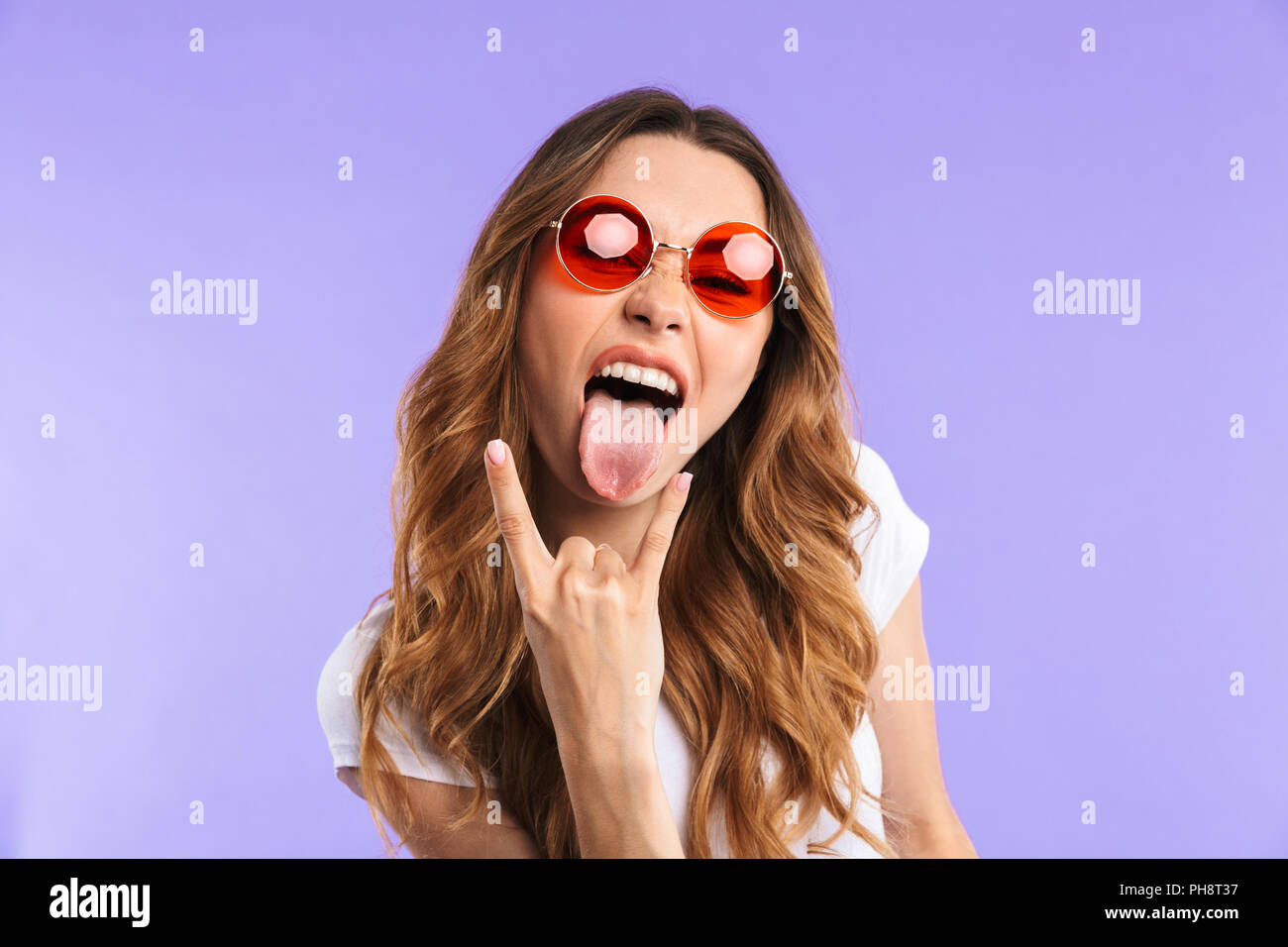 Photo of amazing woman isolated over purple wall background showing ...