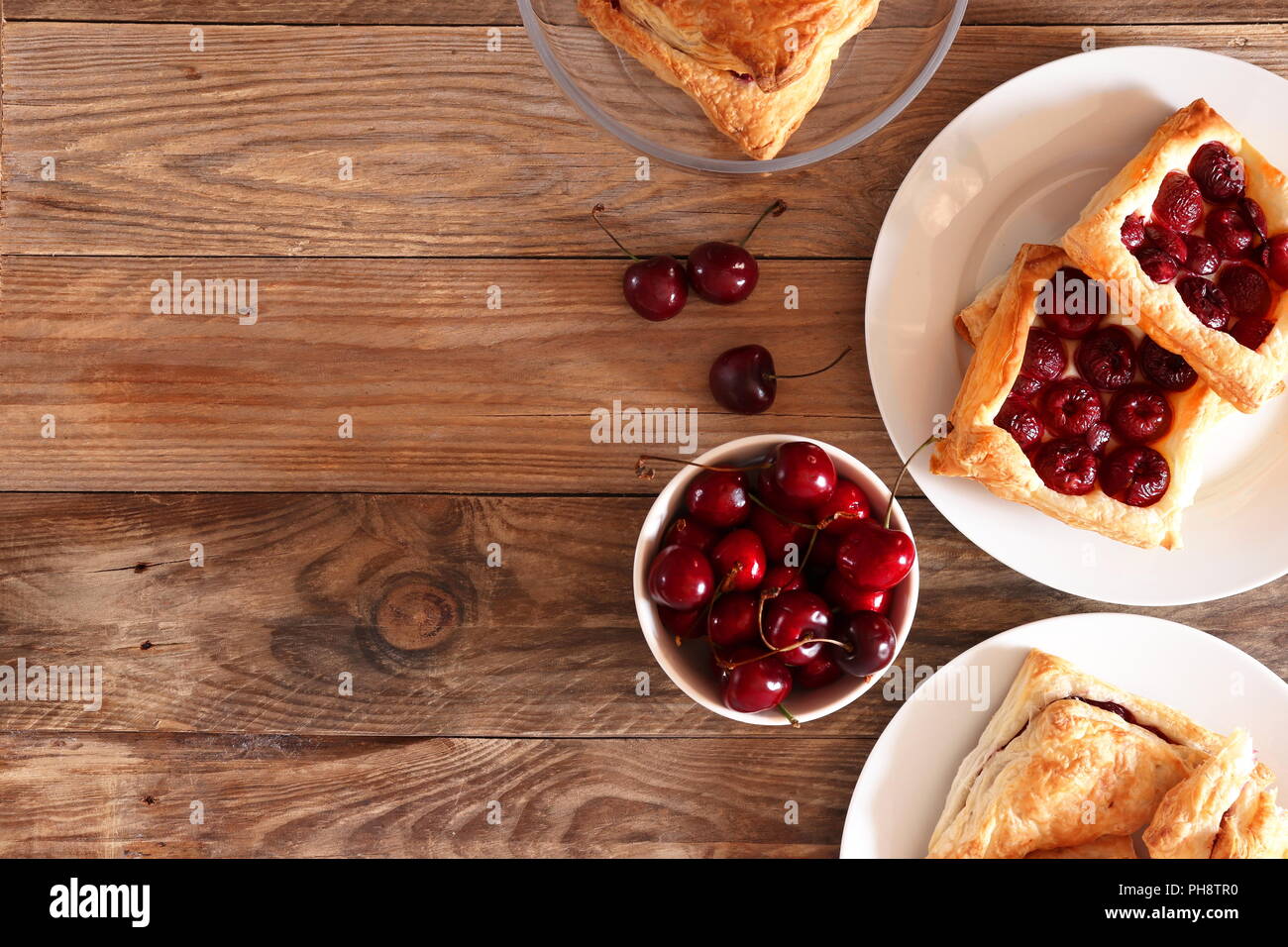 Freshly baked puff pastry squares with cherries, flat lay Stock Photo ...