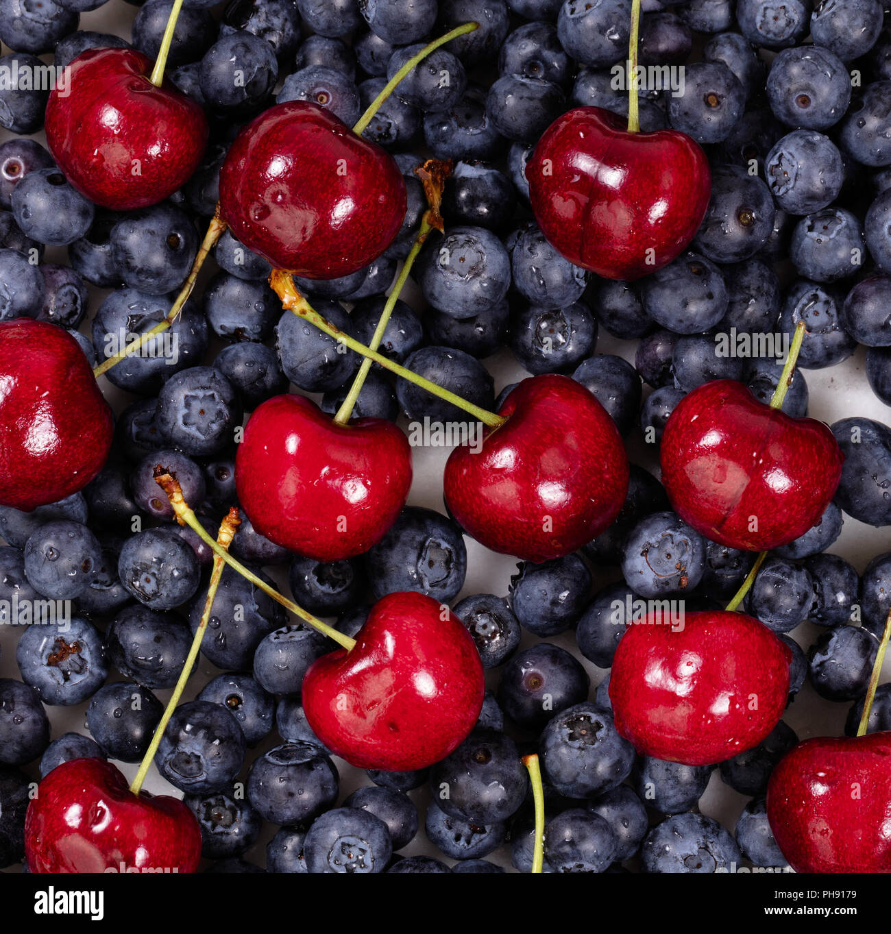 Fresh blueberries and cherries in filled frame format Stock Photo - Alamy