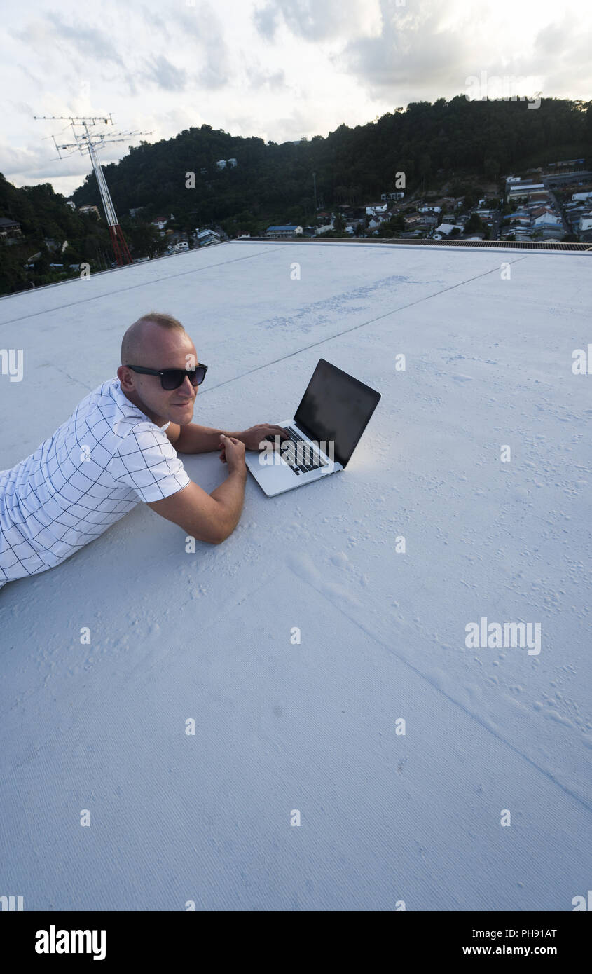 Outdoors portrait of handsome young man with laptop computer Stock ...