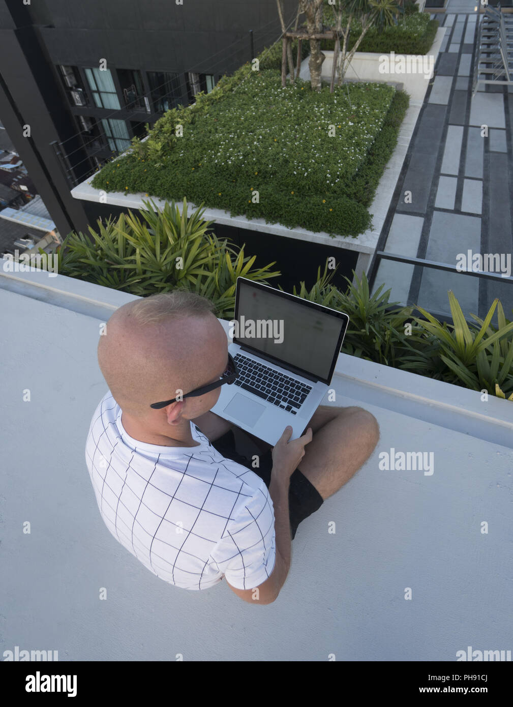Rooftop man hi-res stock photography and images - Alamy