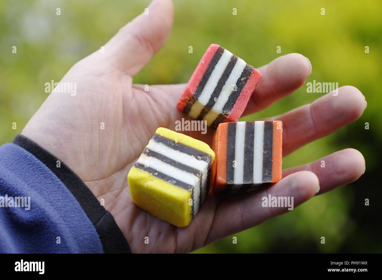 Hand with candy hi-res stock photography and images - Alamy