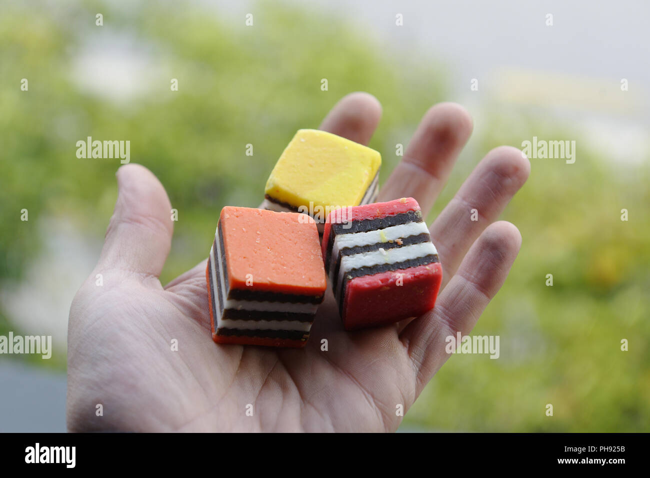 Hand with candy Stock Photo - Alamy