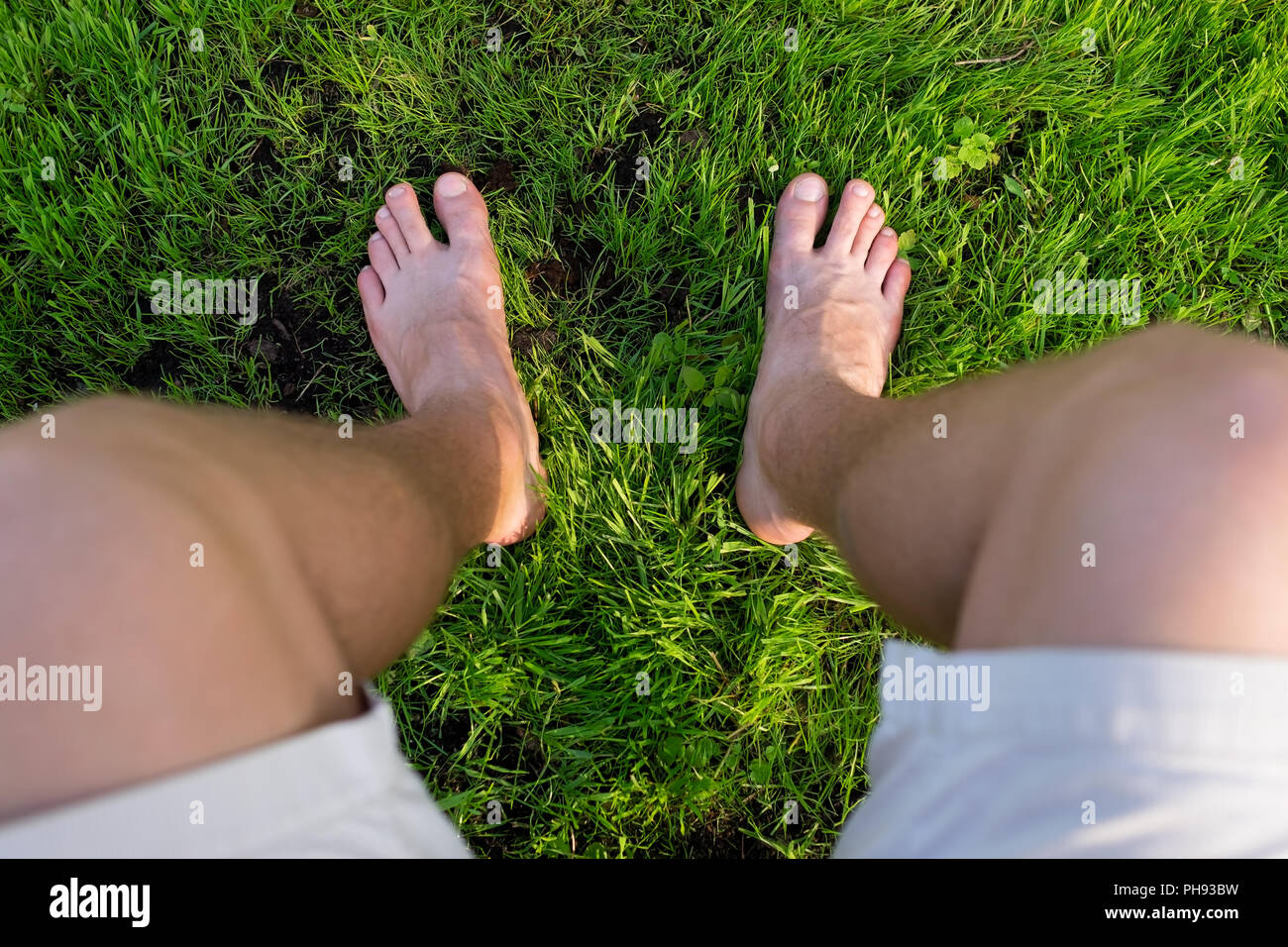 European man foot over green grass. Top view Stock Photo - Alamy
