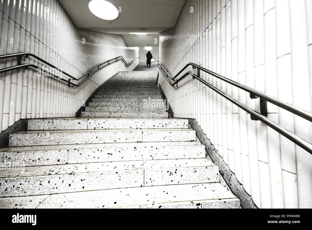 Person going up subway stairs Stock Photo - Alamy