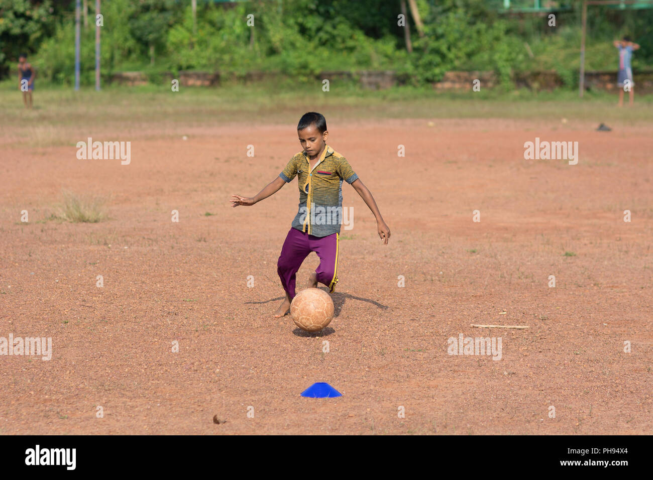 Mumbai, India - July 8, 2018 - Indian kids playing football on dusty ...