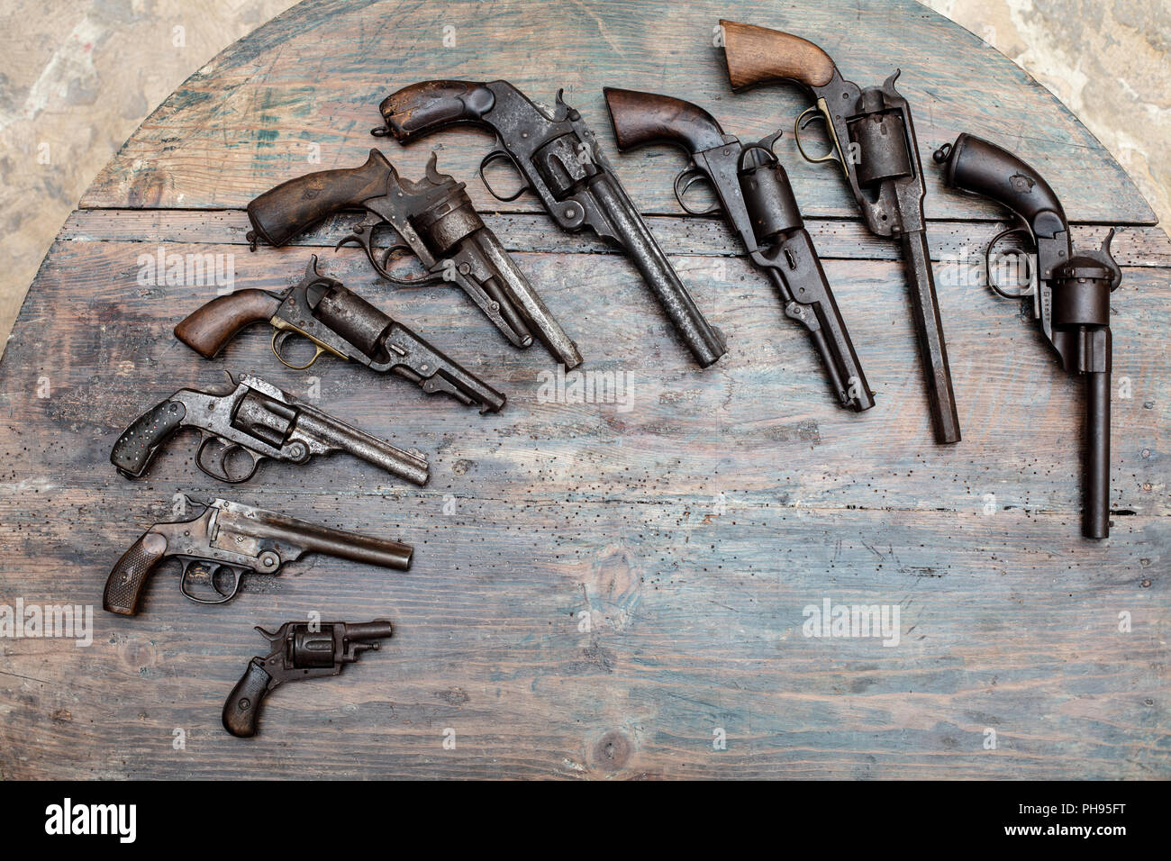 High resolution image of historical guns and pistols on a vintage wood ...