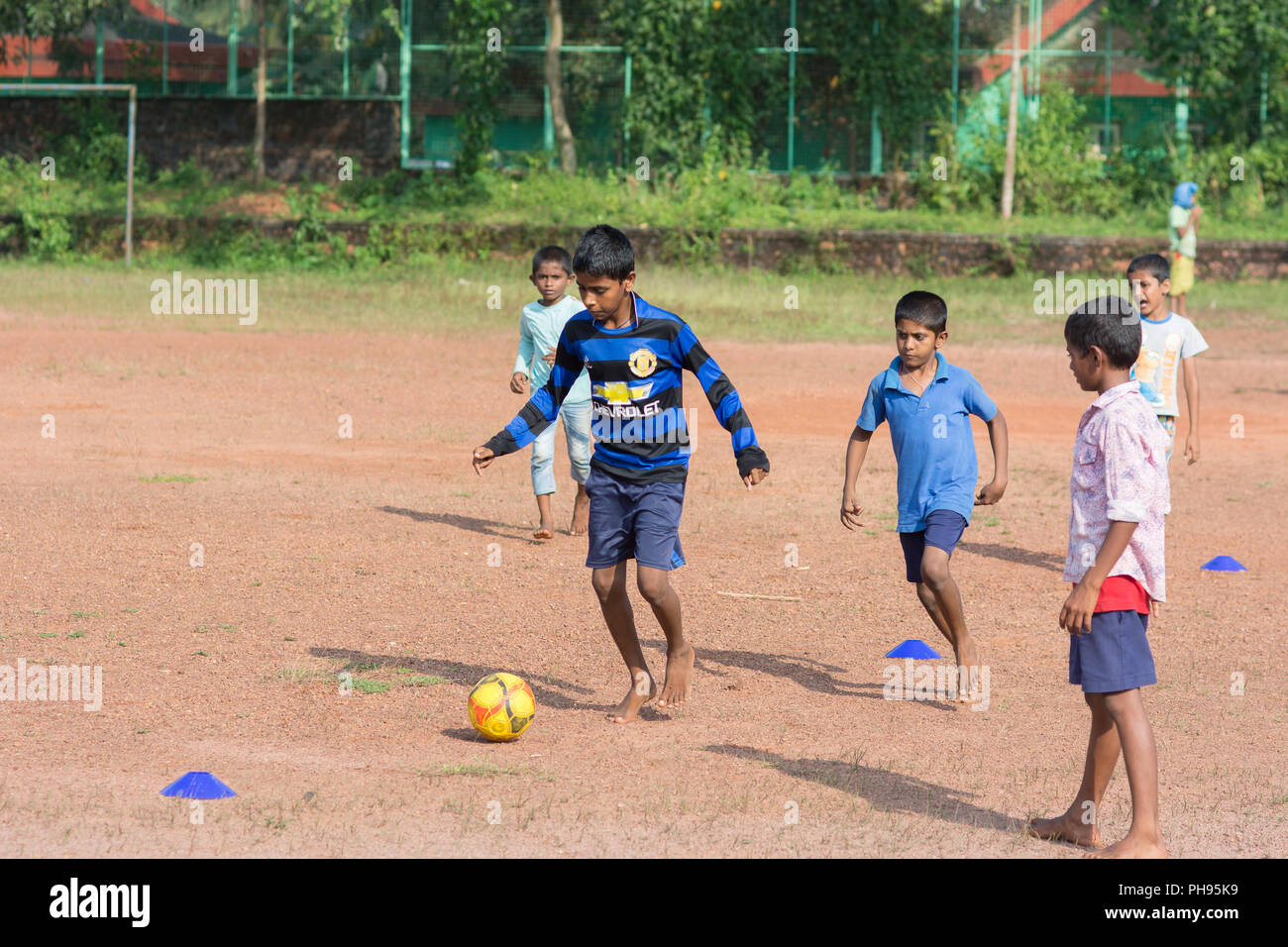 Mumbai, India - July 8, 2018 - Indian kids playing football on dusty ...
