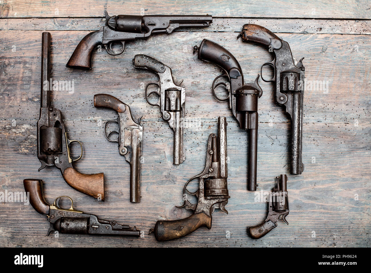 Display case with old historical guns and pistols on a vintage wood ...