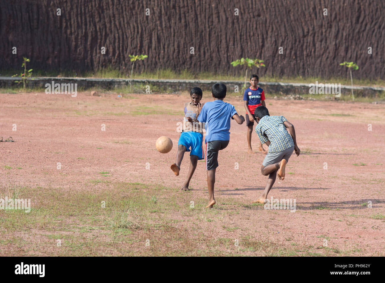 Mumbai, India - July 8, 2018 - Indian kids playing football on dusty ...