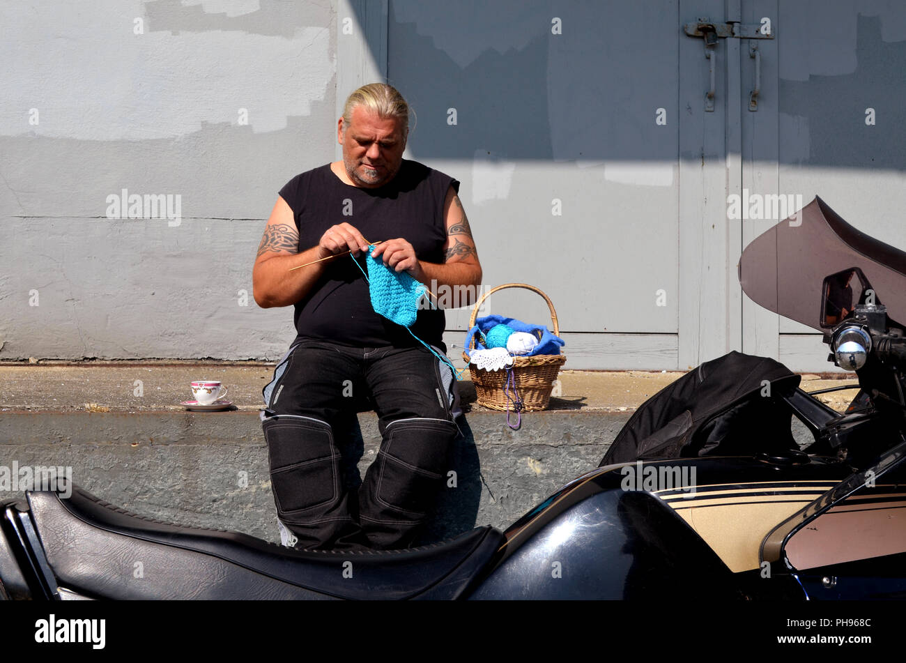 Tough biker caught knitting and drinking tea Stock Photo - Alamy