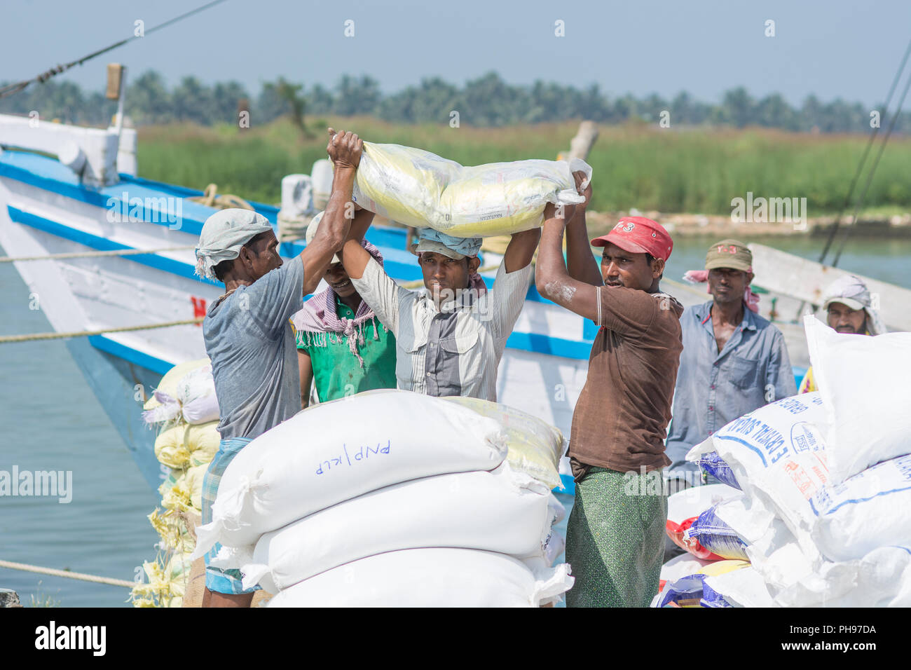 Men carrying bags of cement hi-res stock photography and images - Alamy