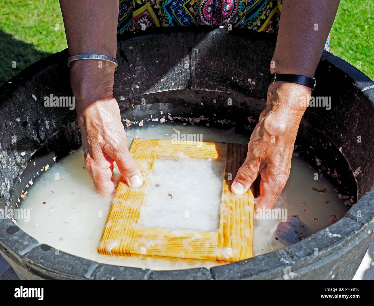 A demonstration of simple paper making. Lifting the frame or deckle ...