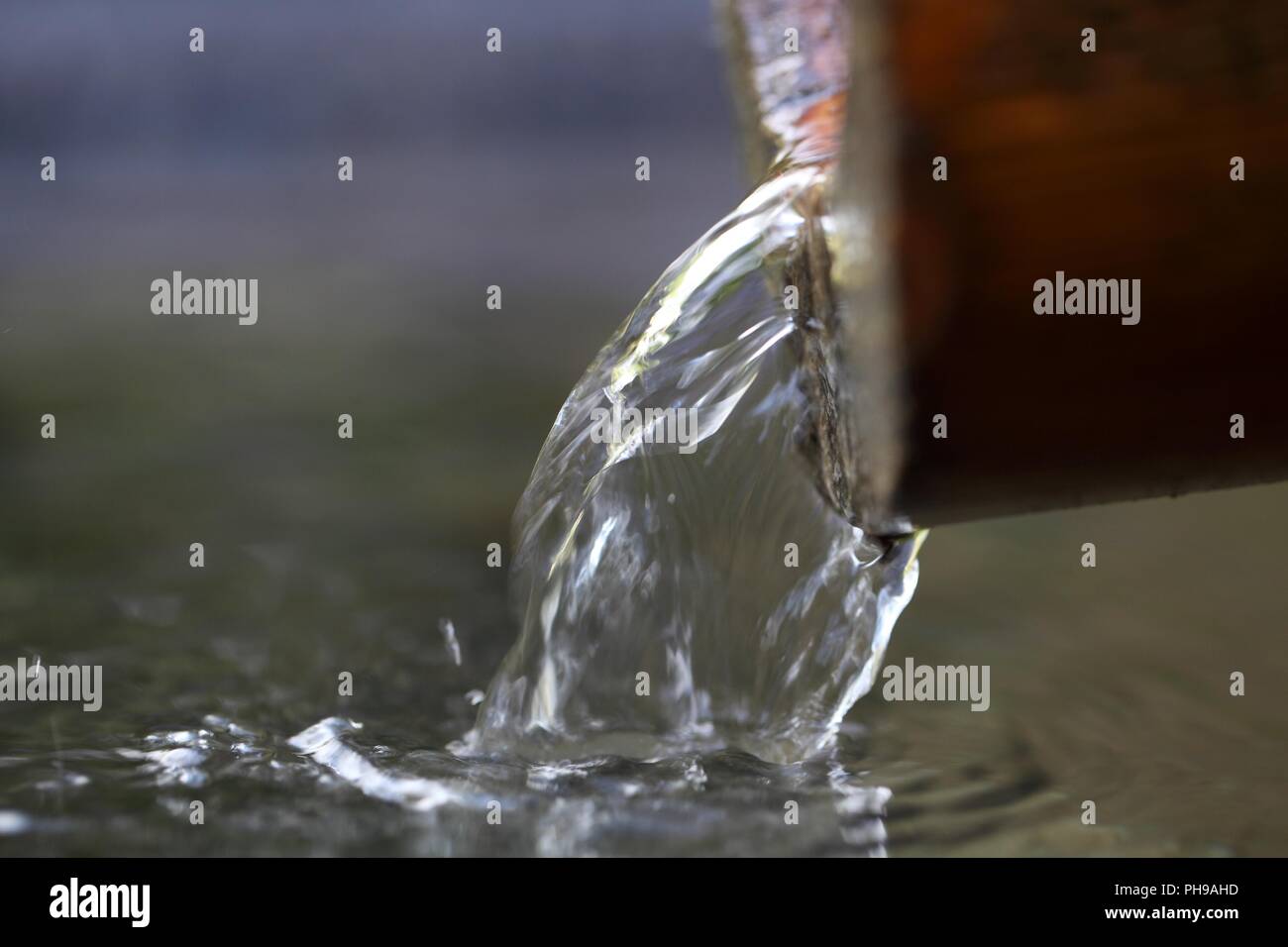 Macro photo of a water stream on a well Stock Photo - Alamy
