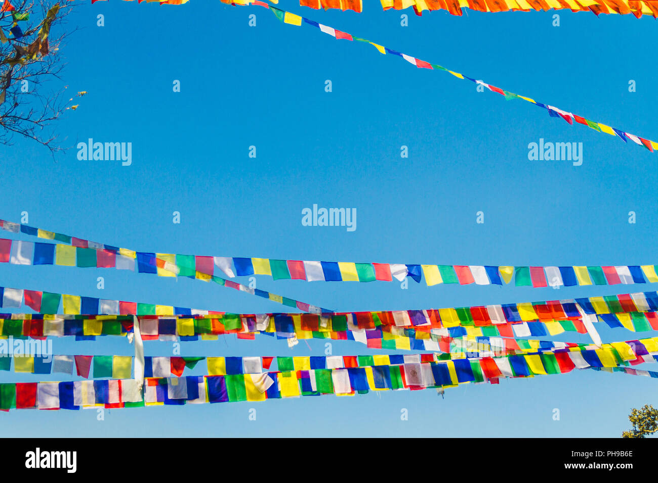 Colorful Prayer Flags with blue sky background Stock Photo - Alamy