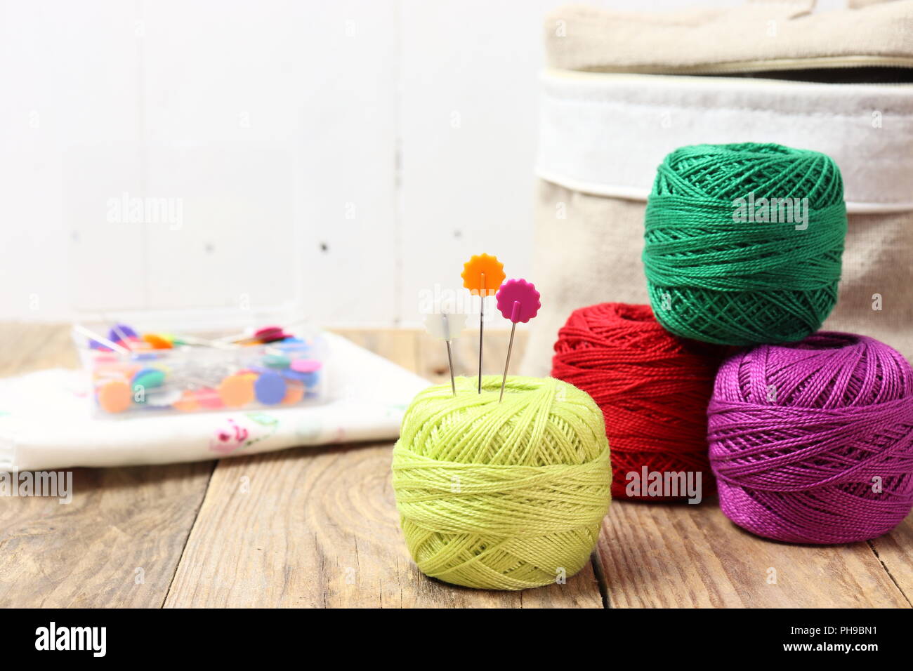 A couple of cotton yarns and decorative pins Stock Photo - Alamy