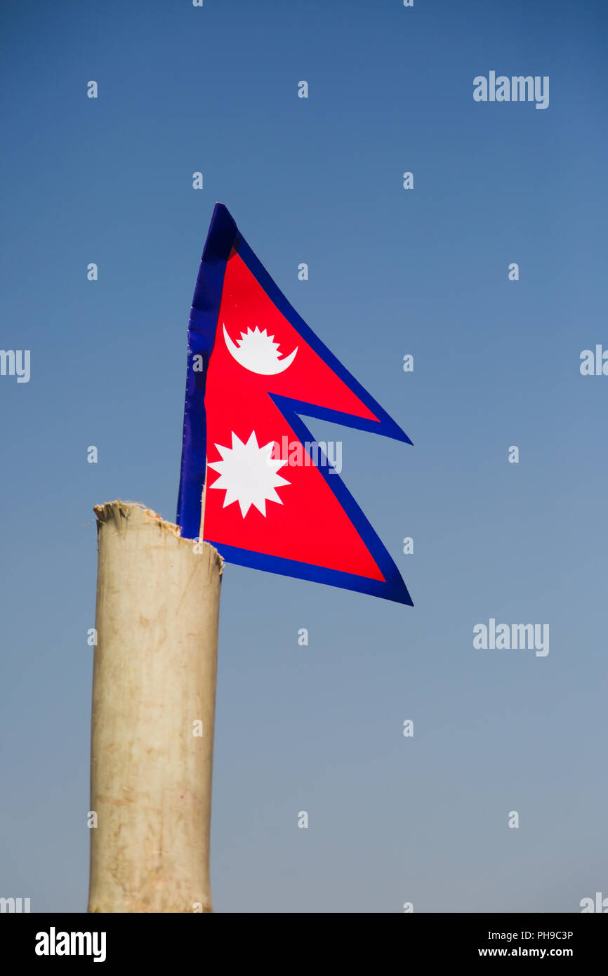 National flag of Nepal with blue sky.The national flag of Nepal is the ...