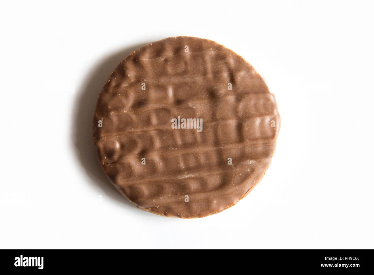 Half covered milk chocolate digestive biscuit on it's own on a white ...