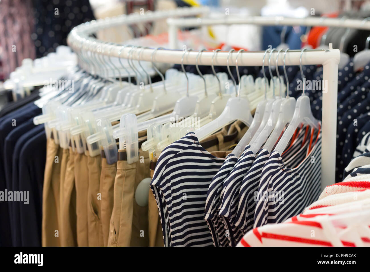 Clothes on hangers in store Stock Photo - Alamy