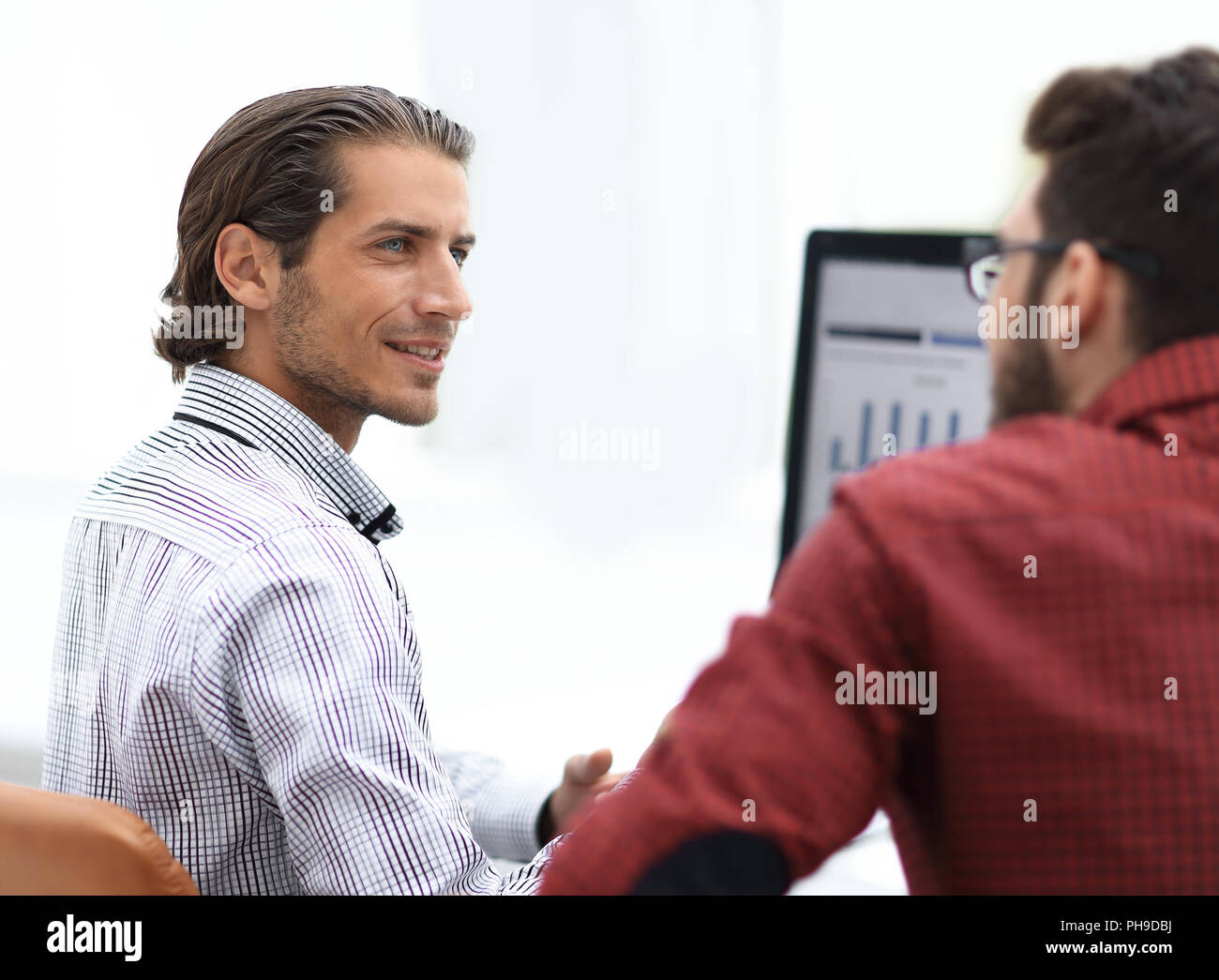 smiling employee talking with a colleague Stock Photo - Alamy