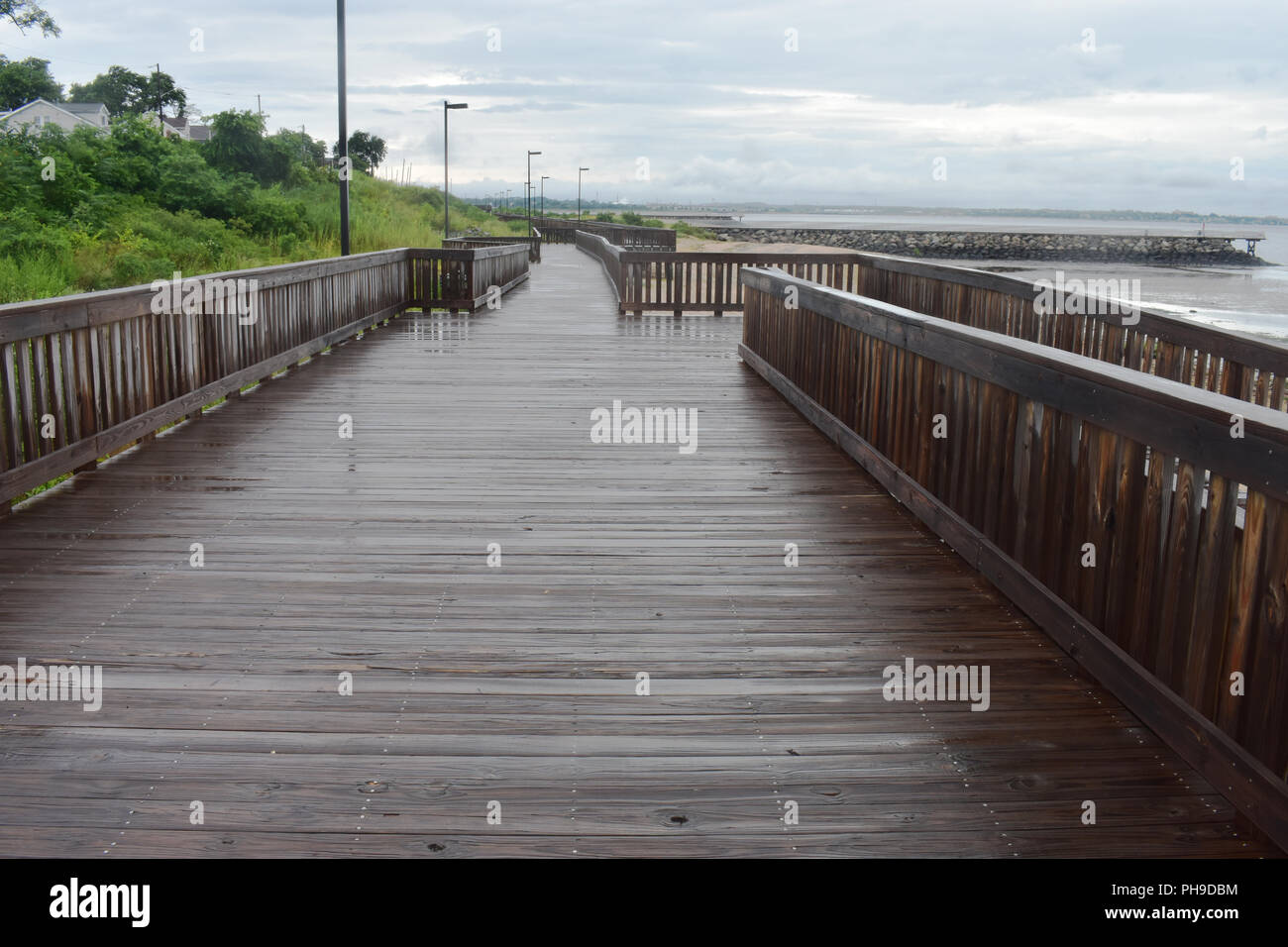 Wet boardwalk after a summer rain storm at the local beach Stock Photo ...