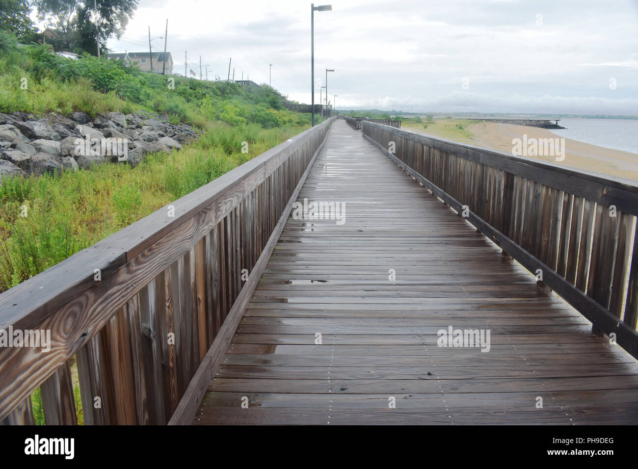 Wet boardwalk after a summer rain storm at the local beach Stock Photo ...