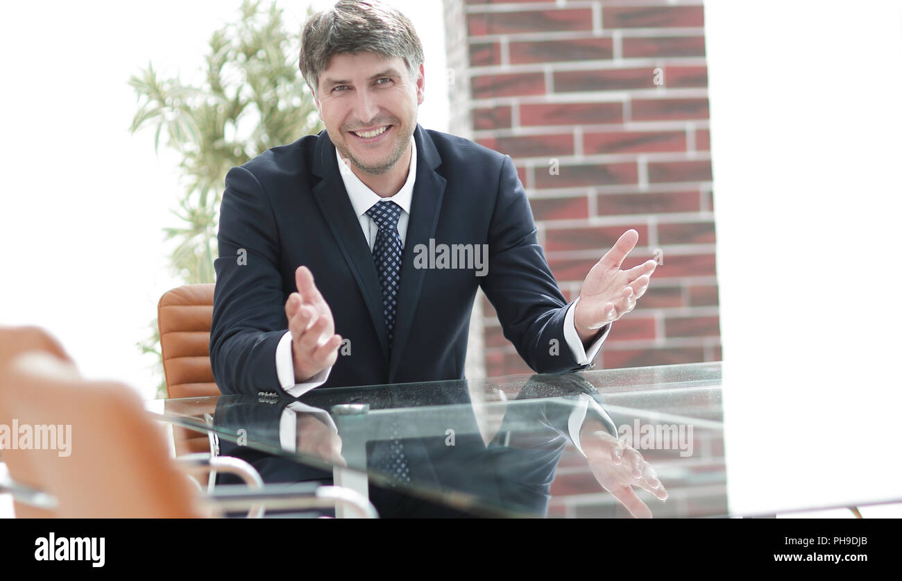 Successful businessman sitting in an empty desk Stock Photo - Alamy