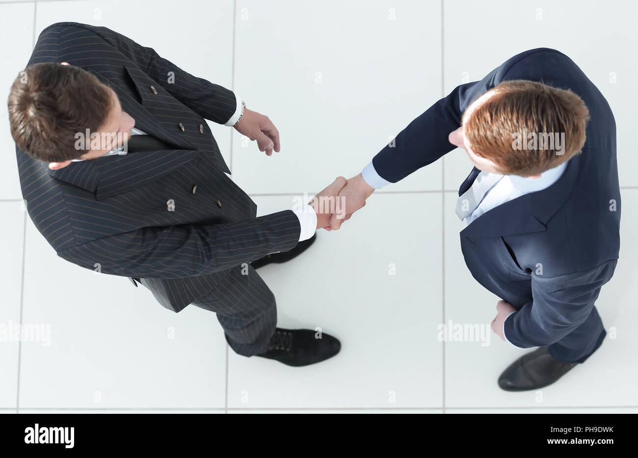 view from the top.handshake, business partners ,isolated on white ...
