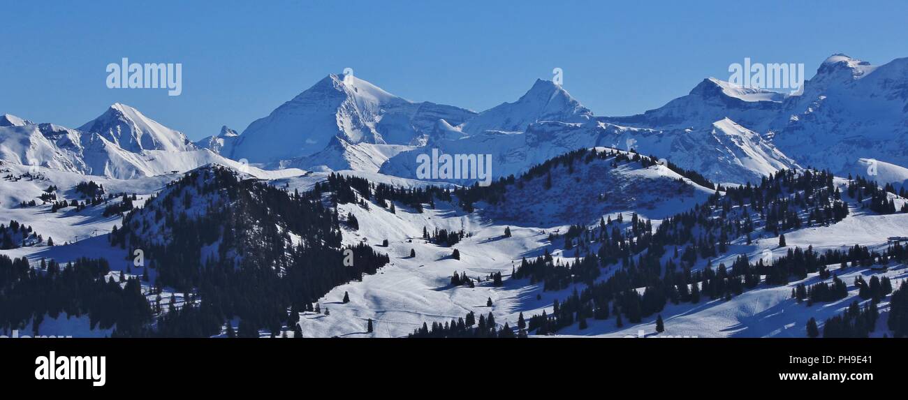 Snow covered mountain range in the Bernese Oberland Stock Photo - Alamy