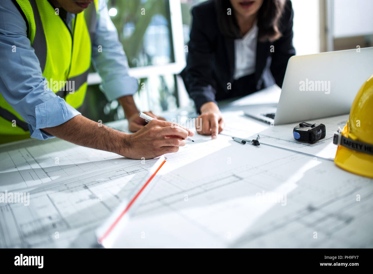 Young male and female architect colleagues drawing graphic planning of ...