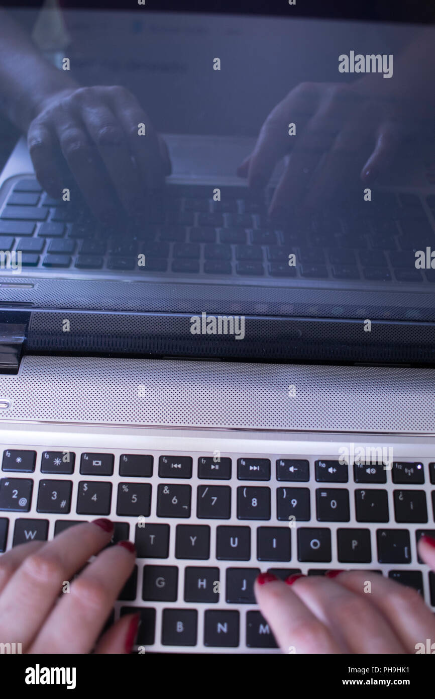 Secretary typist typing on laptop pc computer keyboard keys with hands ...