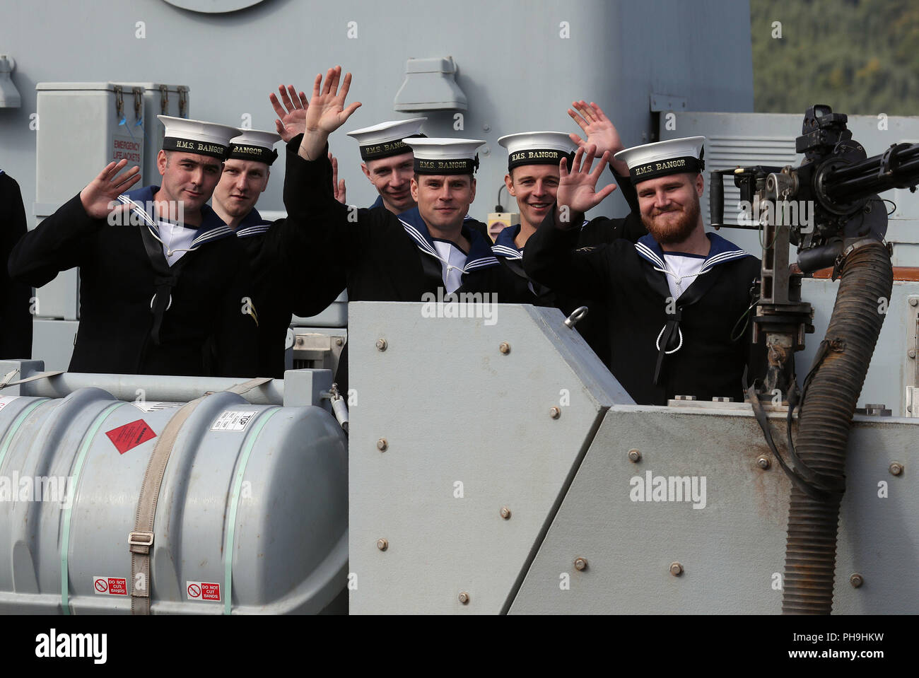 Able seaman Joshua Bertman(R) waves with fellow crew members as the ...