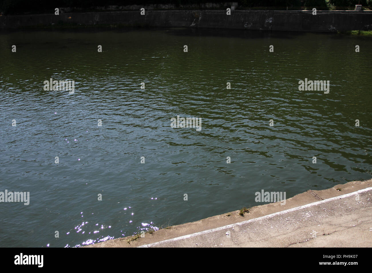 Dam wall and overflow of Iskar Dam. Water flowing over a dam wall. Mist ...