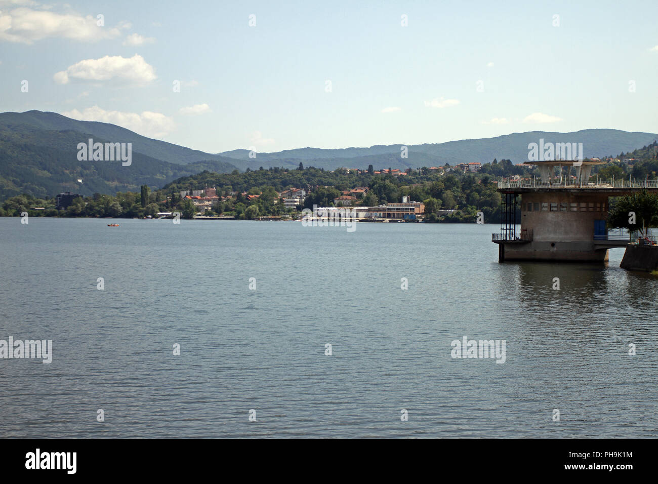 Dam wall and overflow of Iskar Dam. Water flowing over a dam wall. Mist ...
