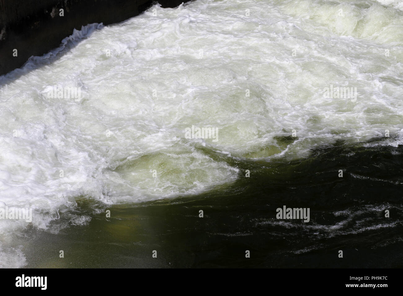 Splashes and spray from waterfall. Big water splash in lake after ...