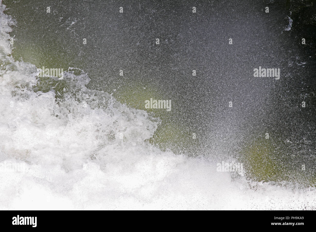 Splashes and spray from waterfall. Big water splash in lake after ...