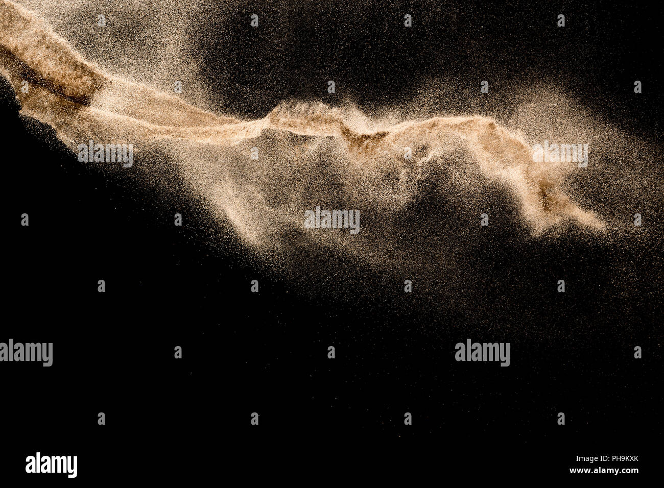 Dry river sand explosion. Golden colored sand splash against dark ...
