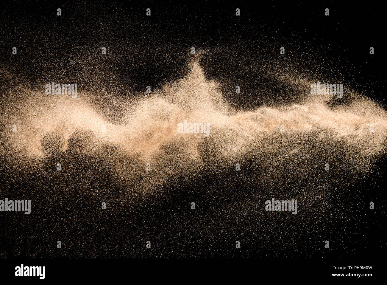 Dry river sand explosion. Golden colored sand splash against dark ...