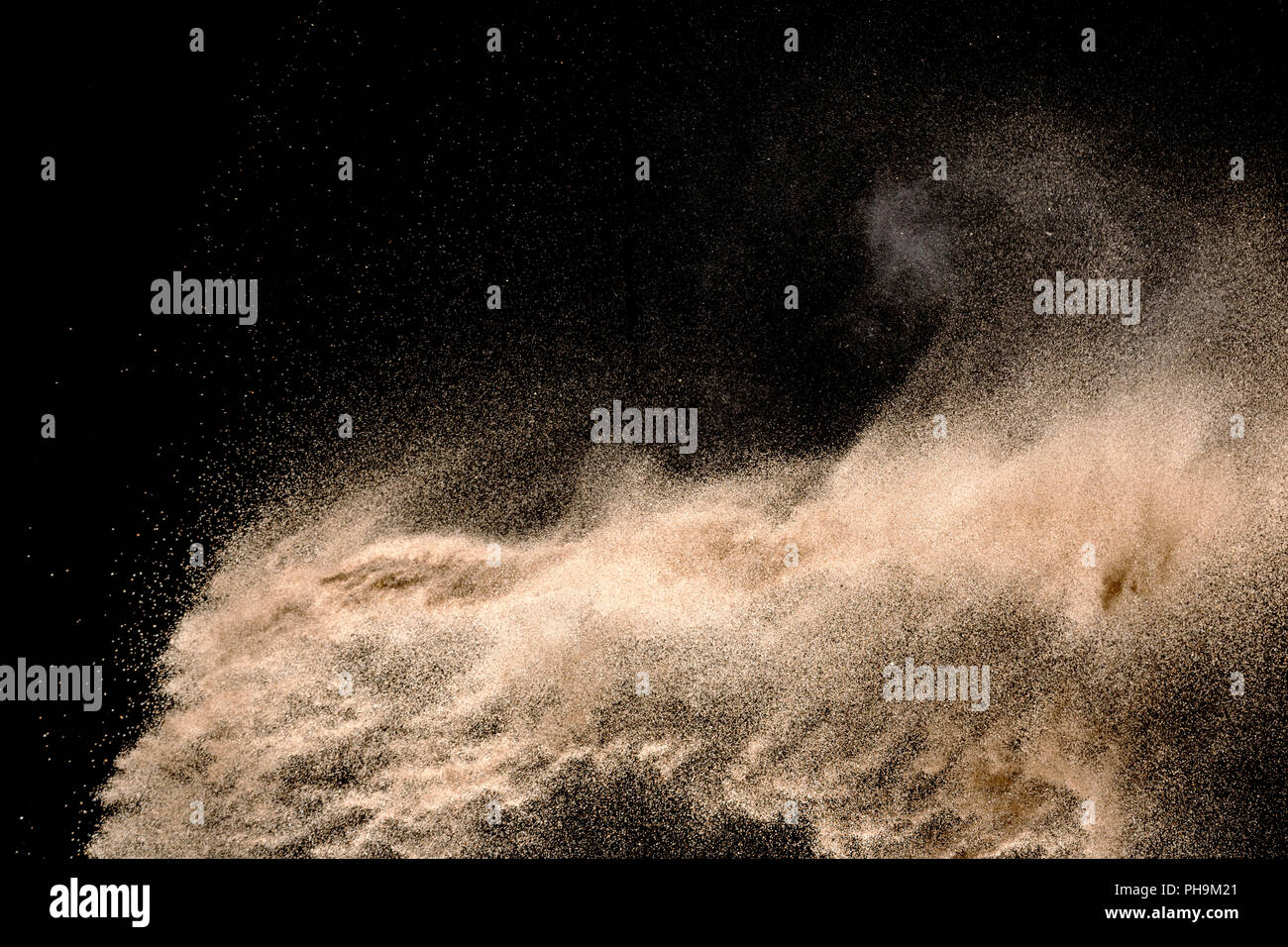 Dry river sand explosion. Golden colored sand splash against dark ...