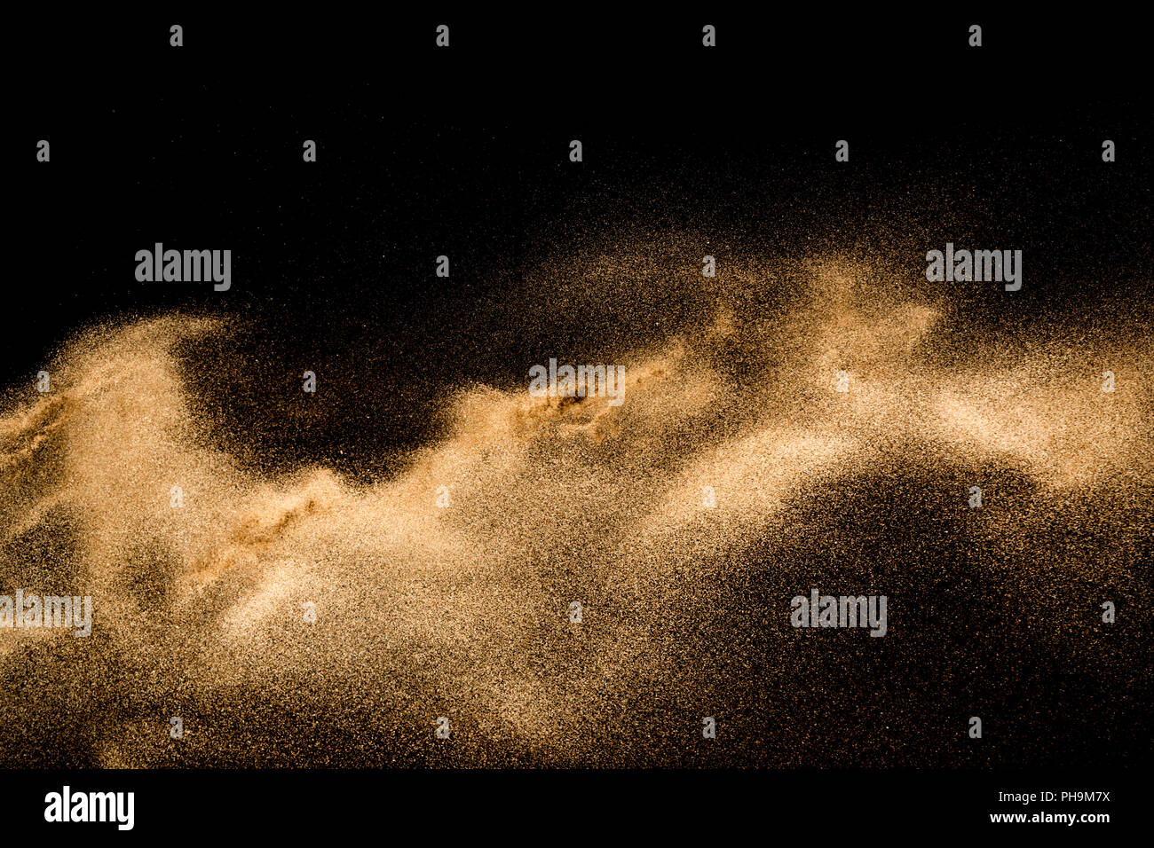 Dry river sand explosion. Golden colored sand splash against dark ...