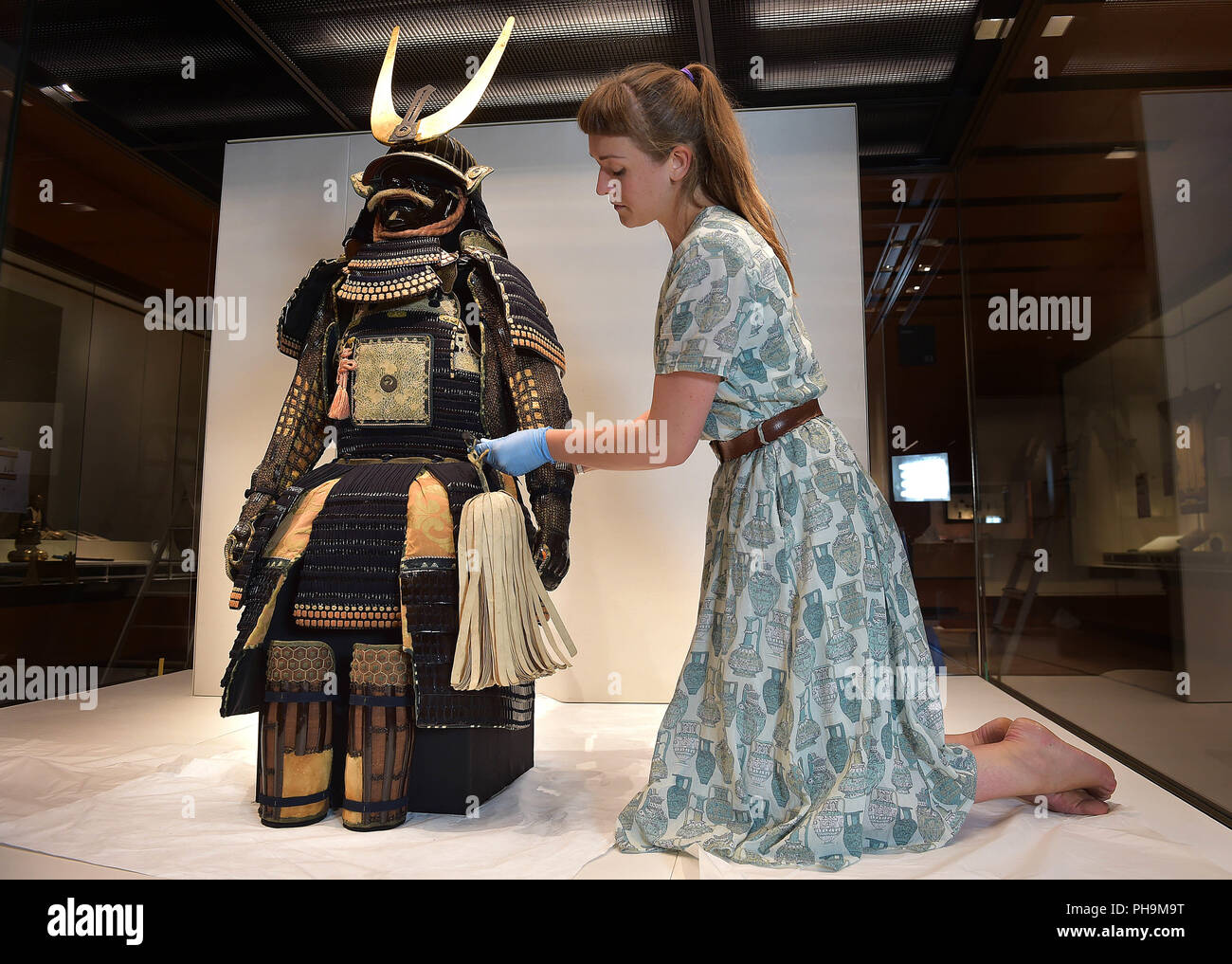 Senior textiles conservator Katy Smith prepares an Edo period set of ...