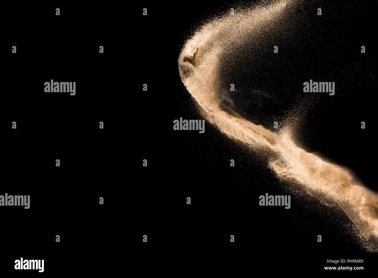 Dry river sand explosion. Golden colored sand splash against black ...