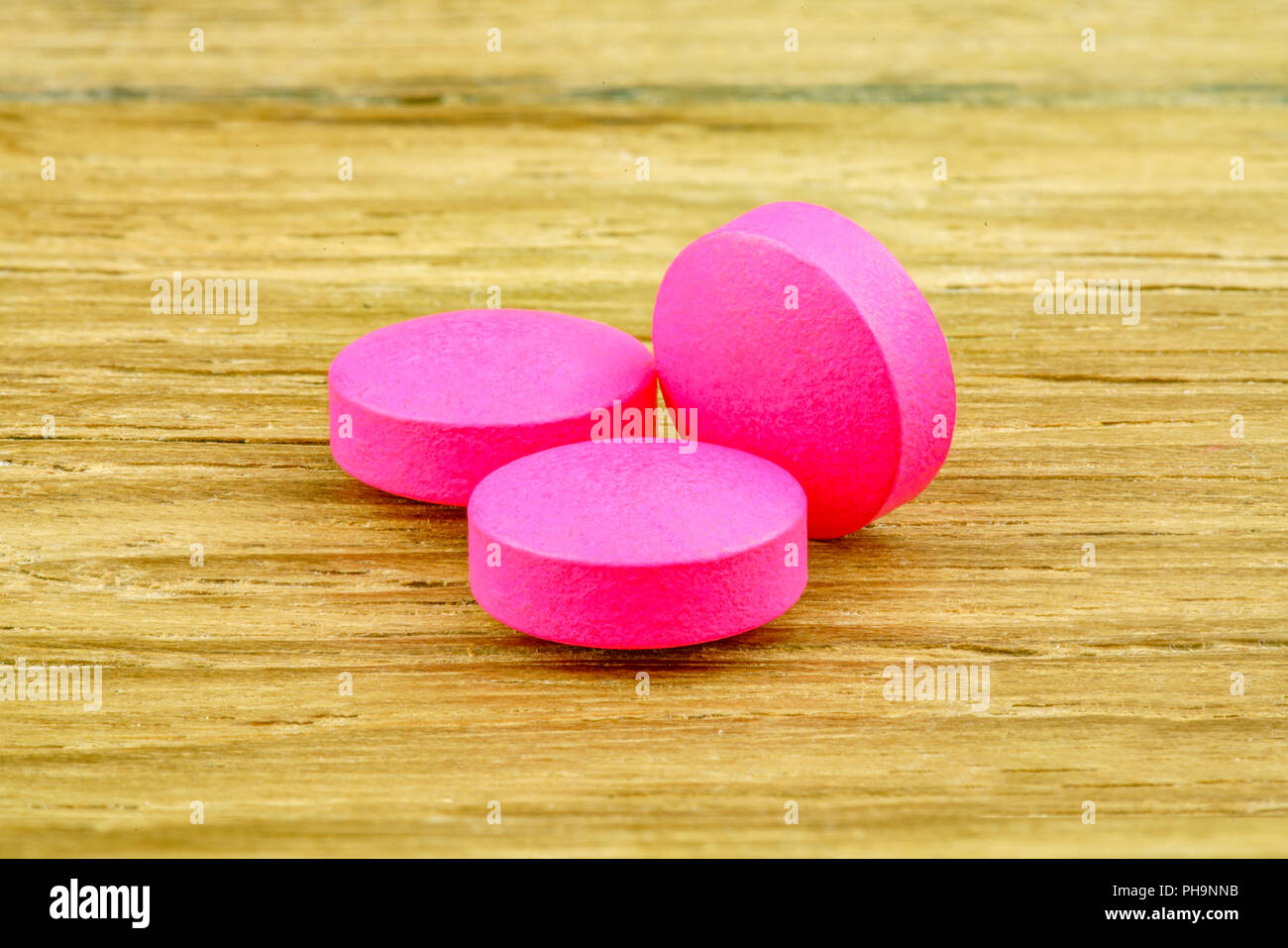 Red tablet of medicine Stock Photo - Alamy