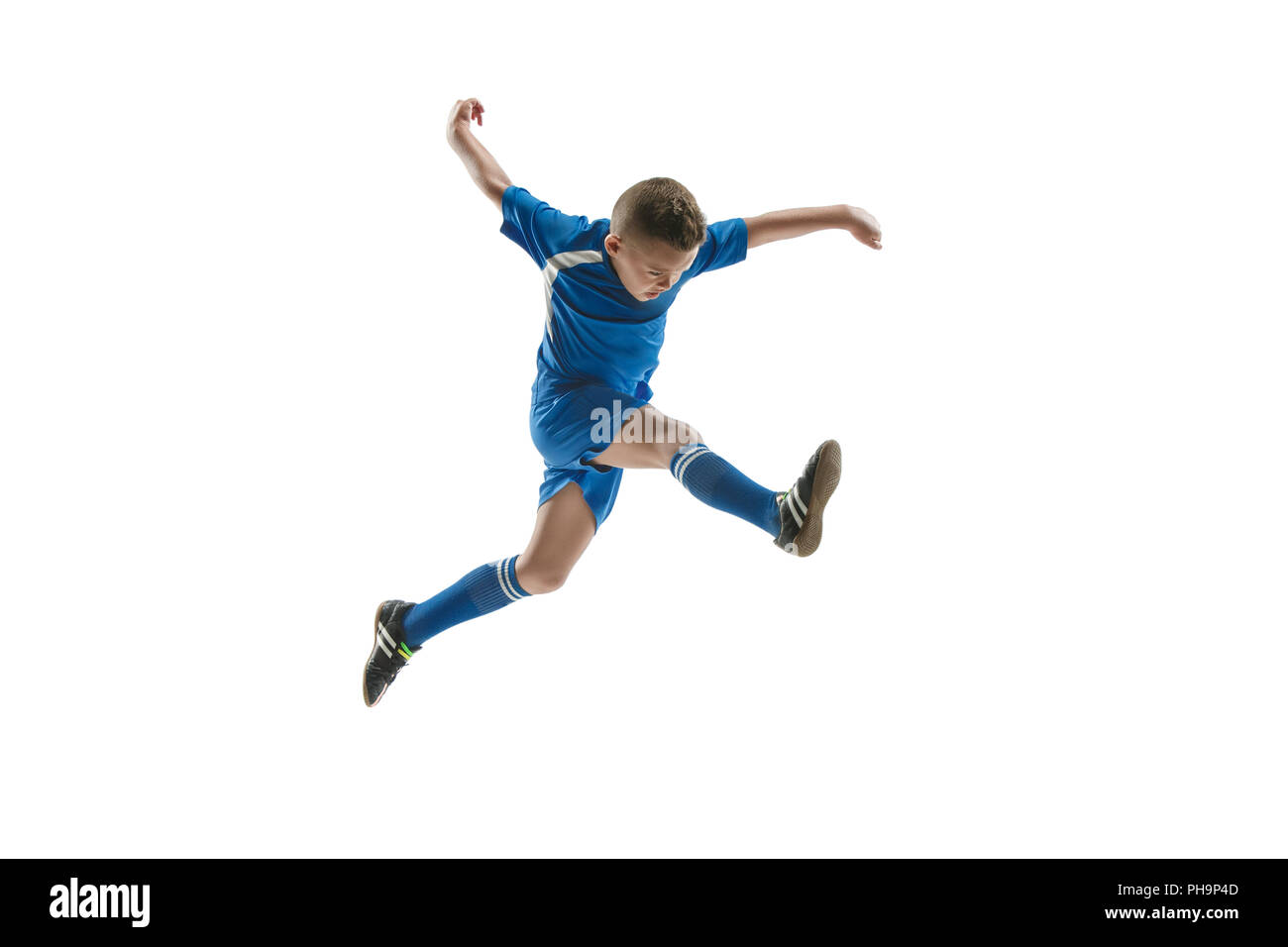 Young boy with soccer ball doing flying kick, isolated on white ...
