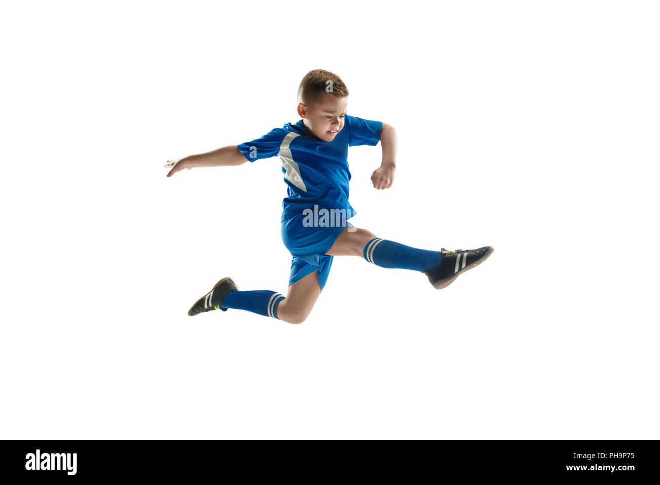 Young boy with soccer ball doing flying kick, isolated on white ...