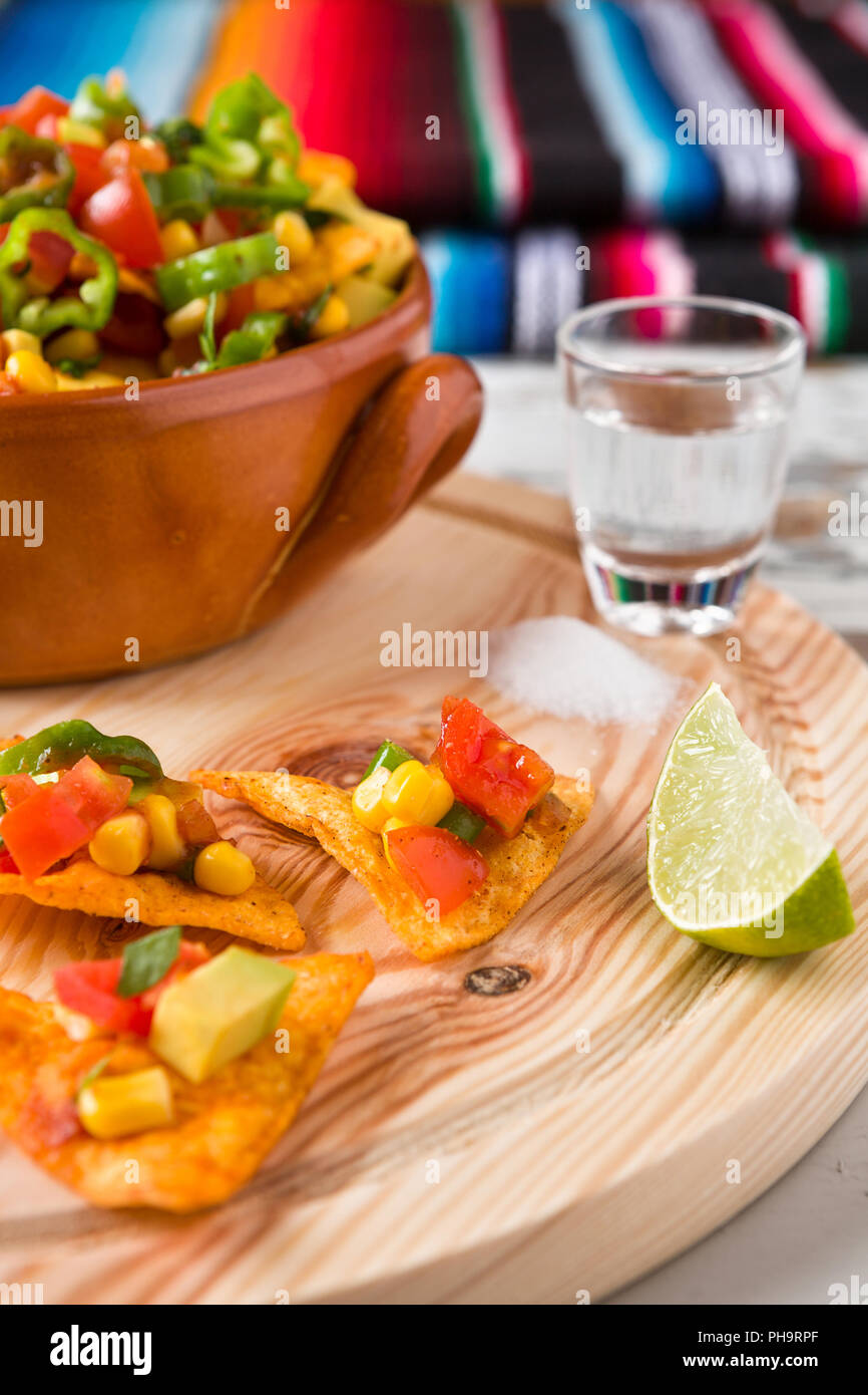 Nachos chips with vegetables tequila lime and salt Stock Photo - Alamy