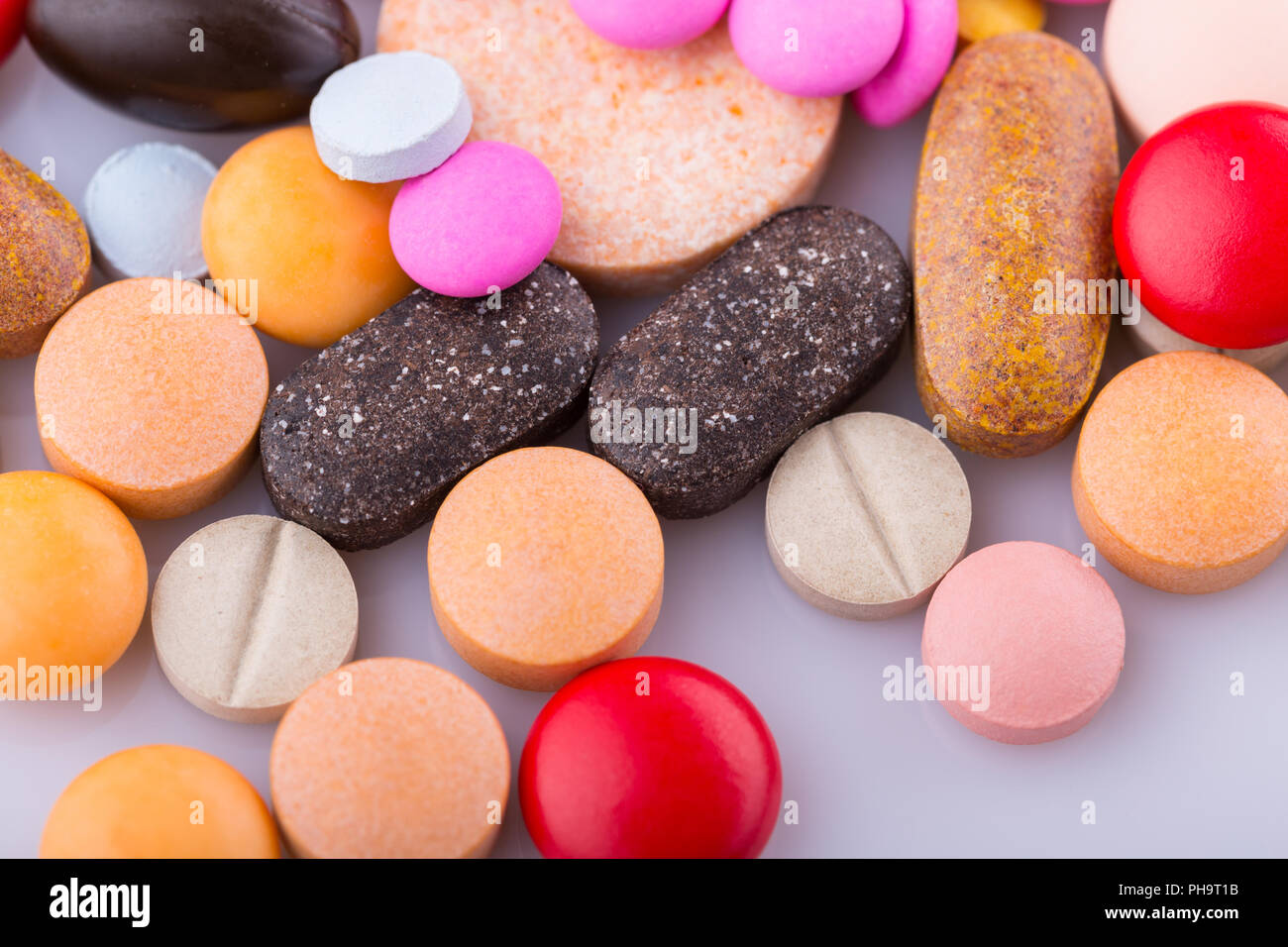 Tablets pills capsule heap mix therapy drugs, over a white background ...