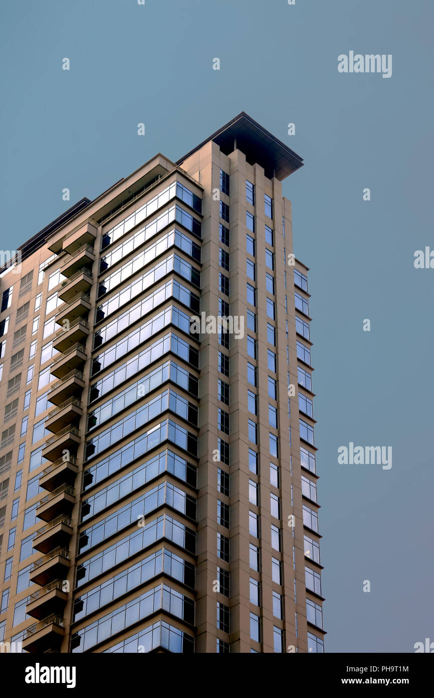 Glass windowed building with artificial blue sky color as the ...