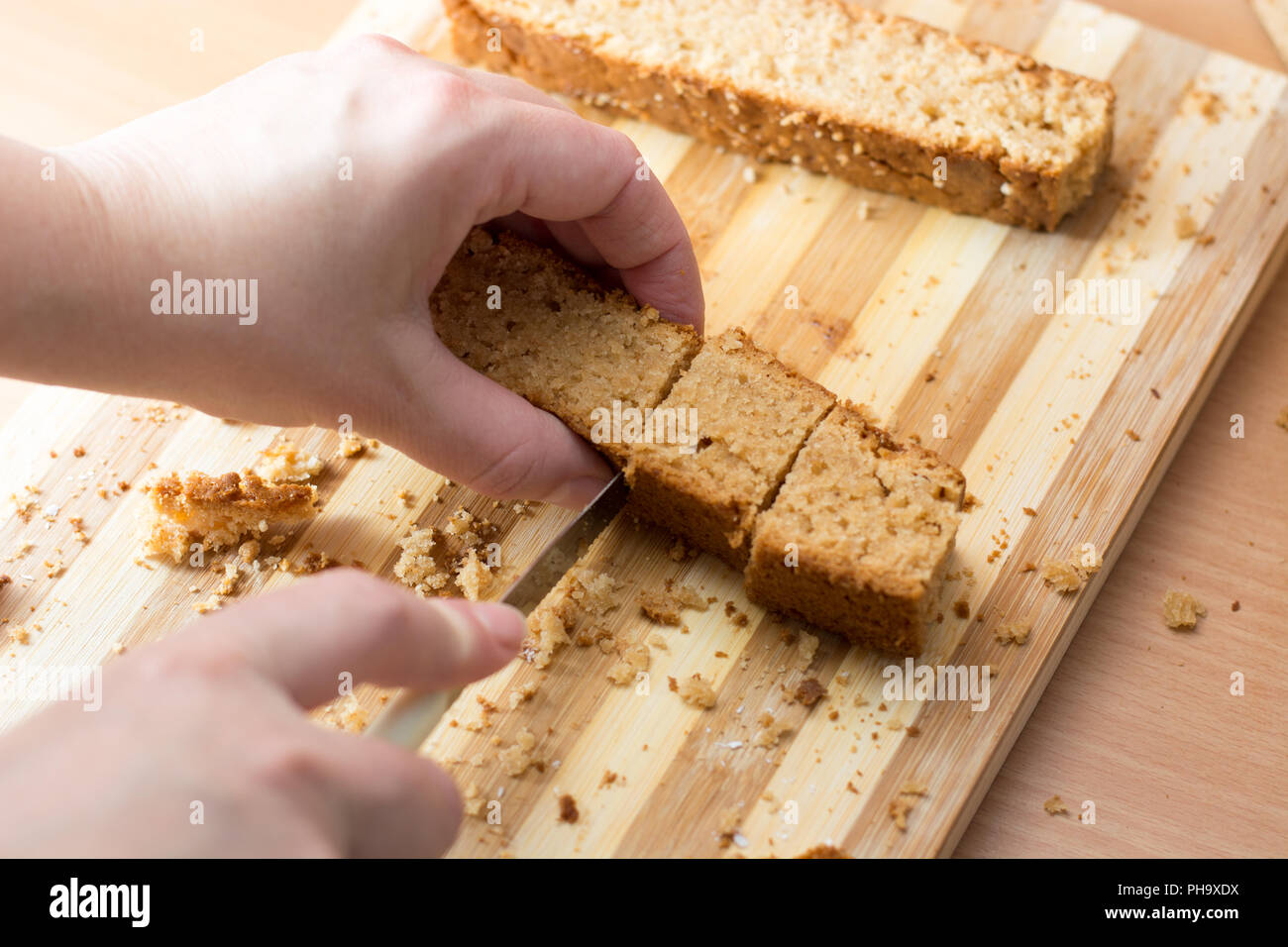 Female hands cutting and preparing cake crust Stock Photo - Alamy
