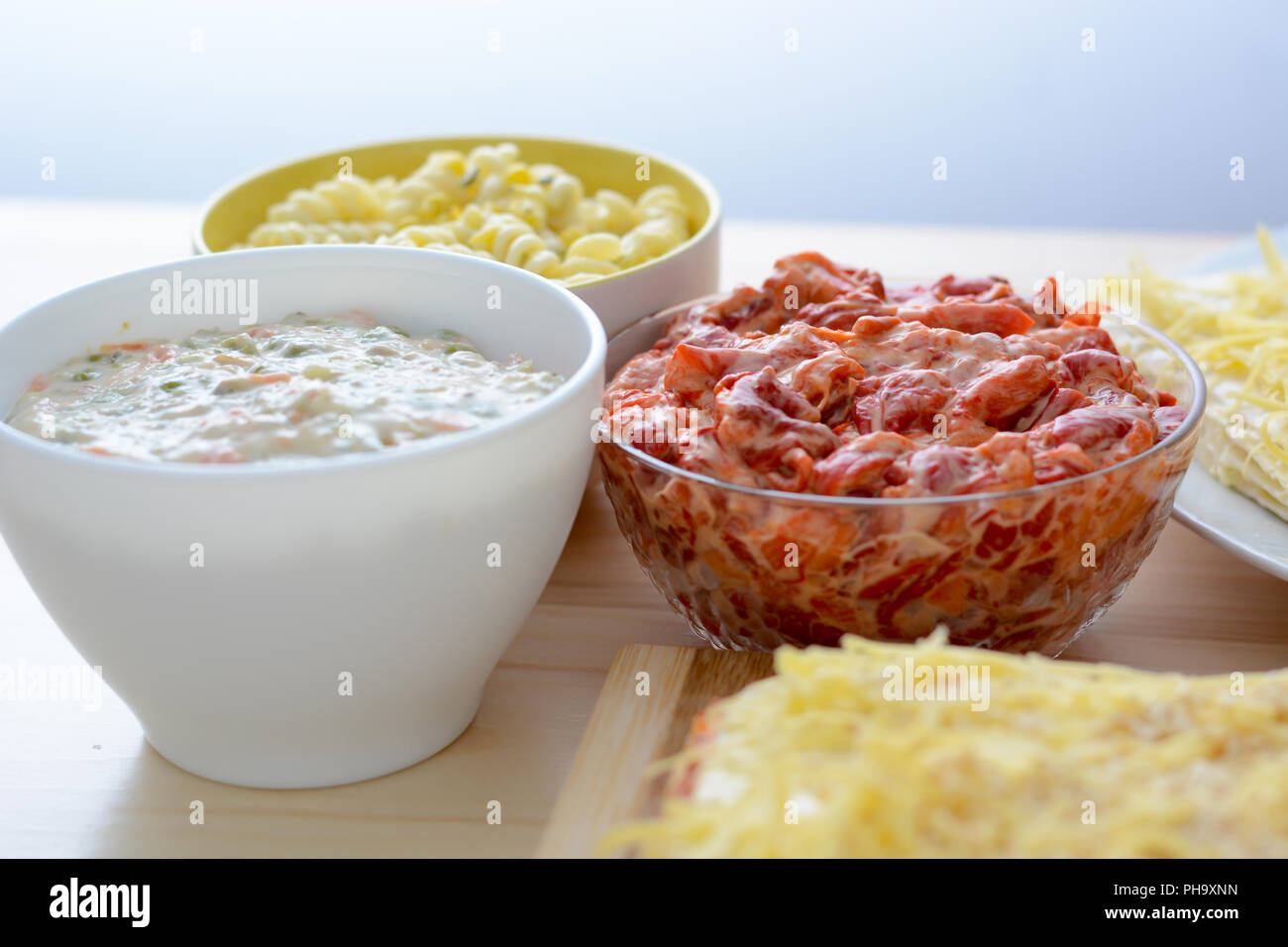 Colorful salads in ceramic bowls and salt cake Stock Photo - Alamy